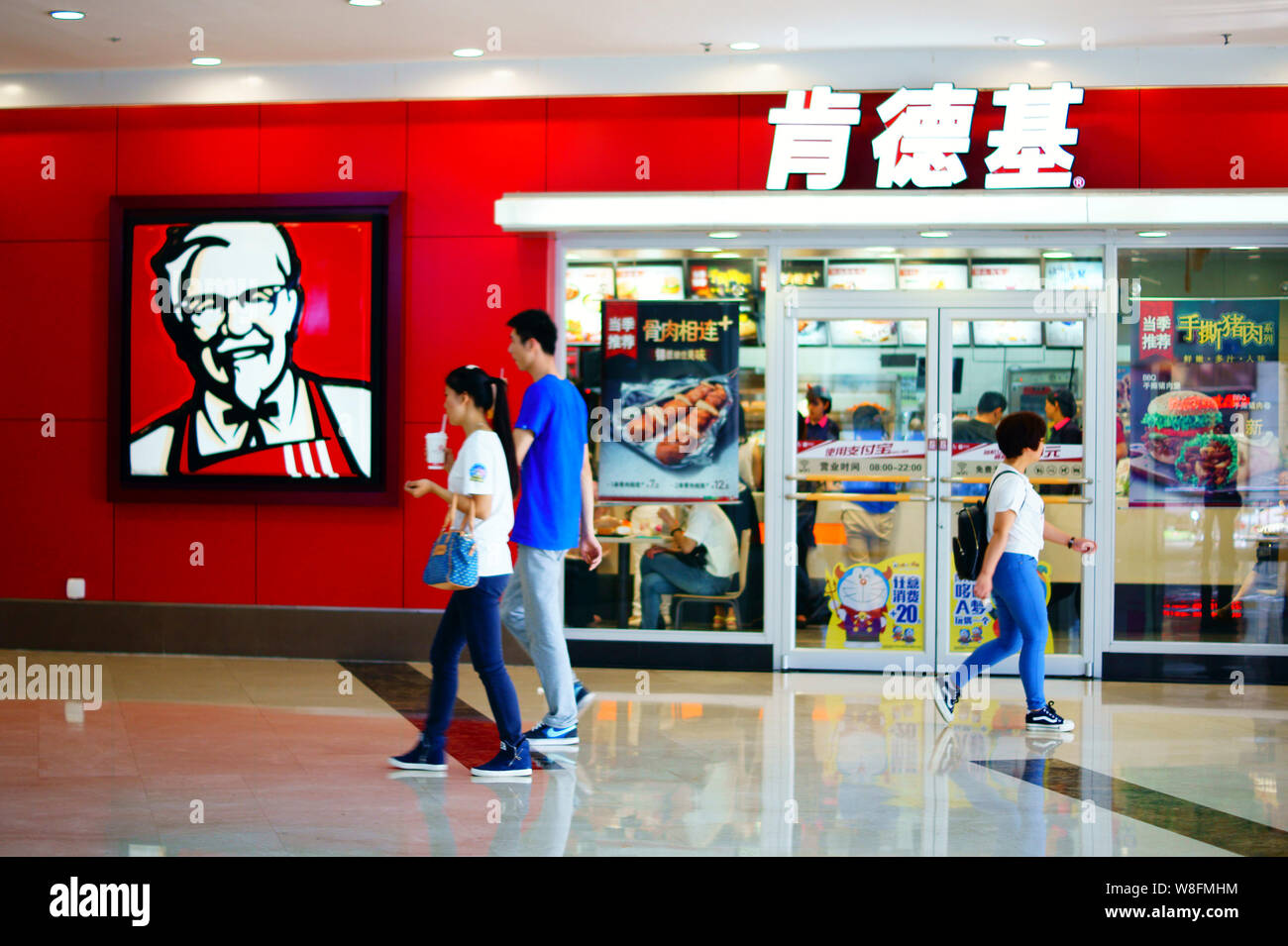 --FILE--Pedestrians walk past a KFC fast food restaurant of Yum Brands ...