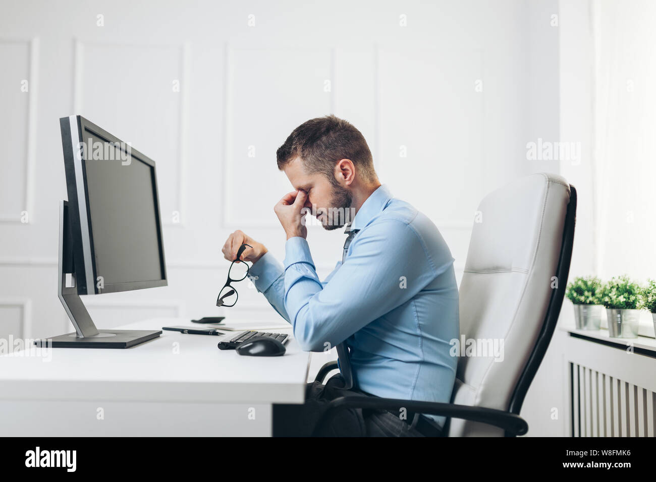 Tired businessman from heavy workload sitting at the desk Stock Photo ...