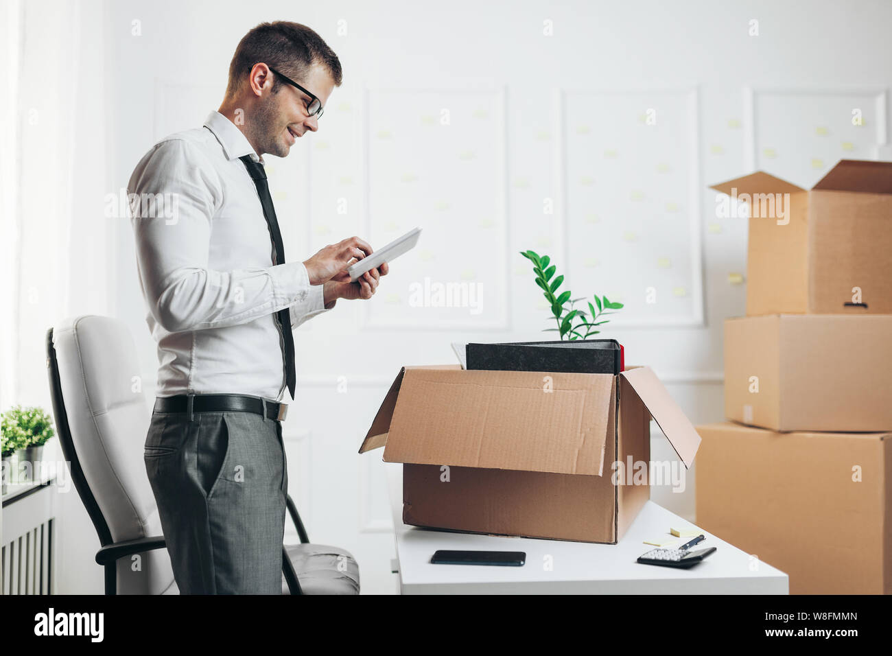 Successful businessman moving into a new office Stock Photo - Alamy