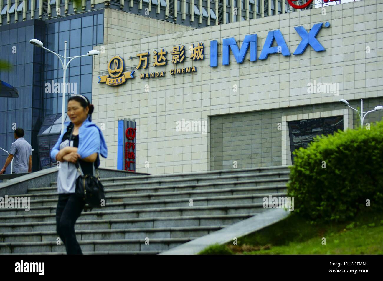 --FILE--A pedestrian walks past a Wanda Cinema featuring IMAX at a ...