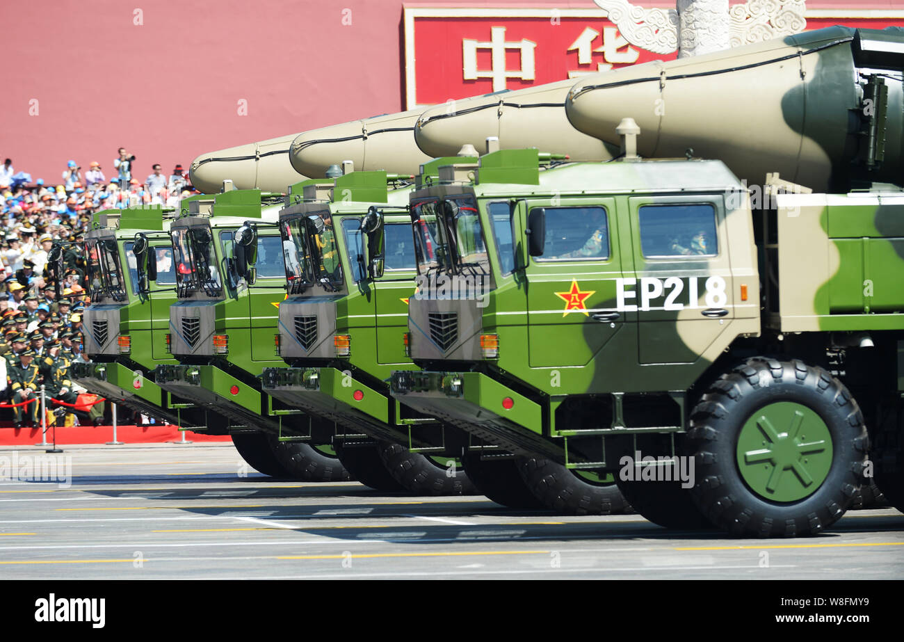 Military vehicles carrying DF-21D anti-ship ballistic missiles march ...