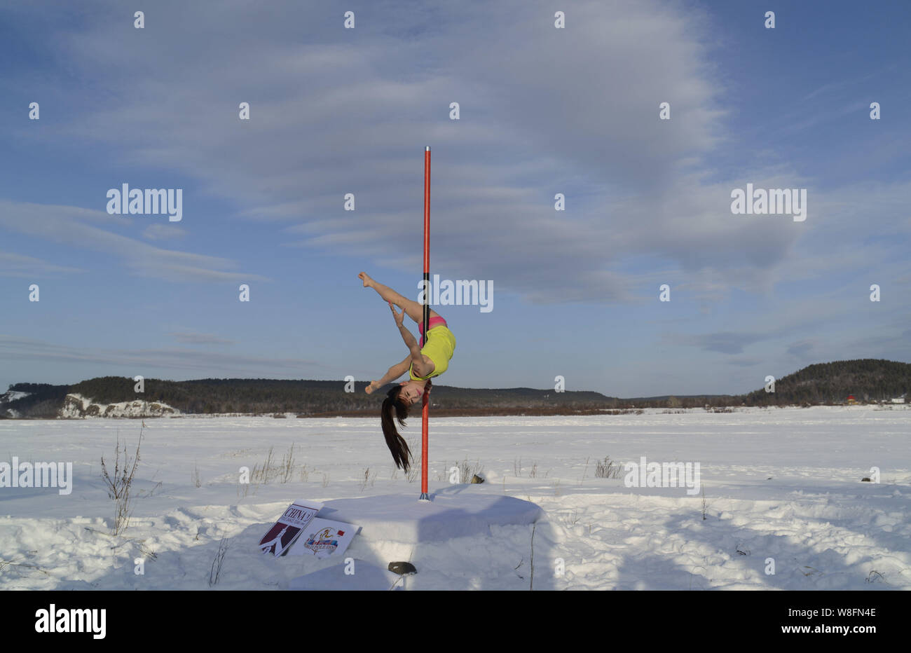 --FILE--A member of China's National Pole Dancing Team performs in the ...
