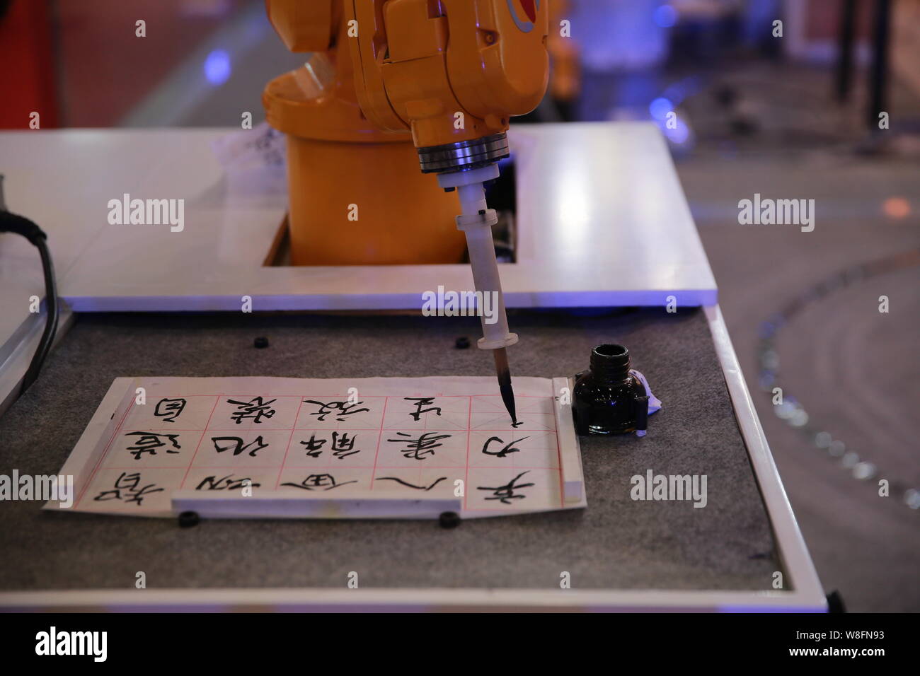 A robot that can write Chinese calligraphy is on display during the ...