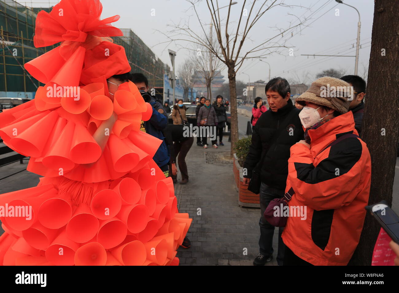 Chinese artist Kong Ning wearing an orange face mask and an orange ...