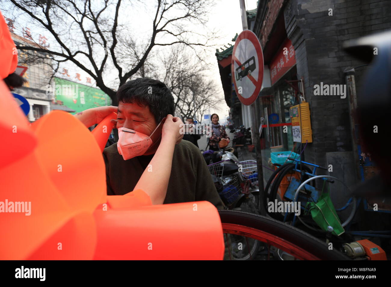 Chinese artist Kong Ning wearing an orange face mask and an orange ...