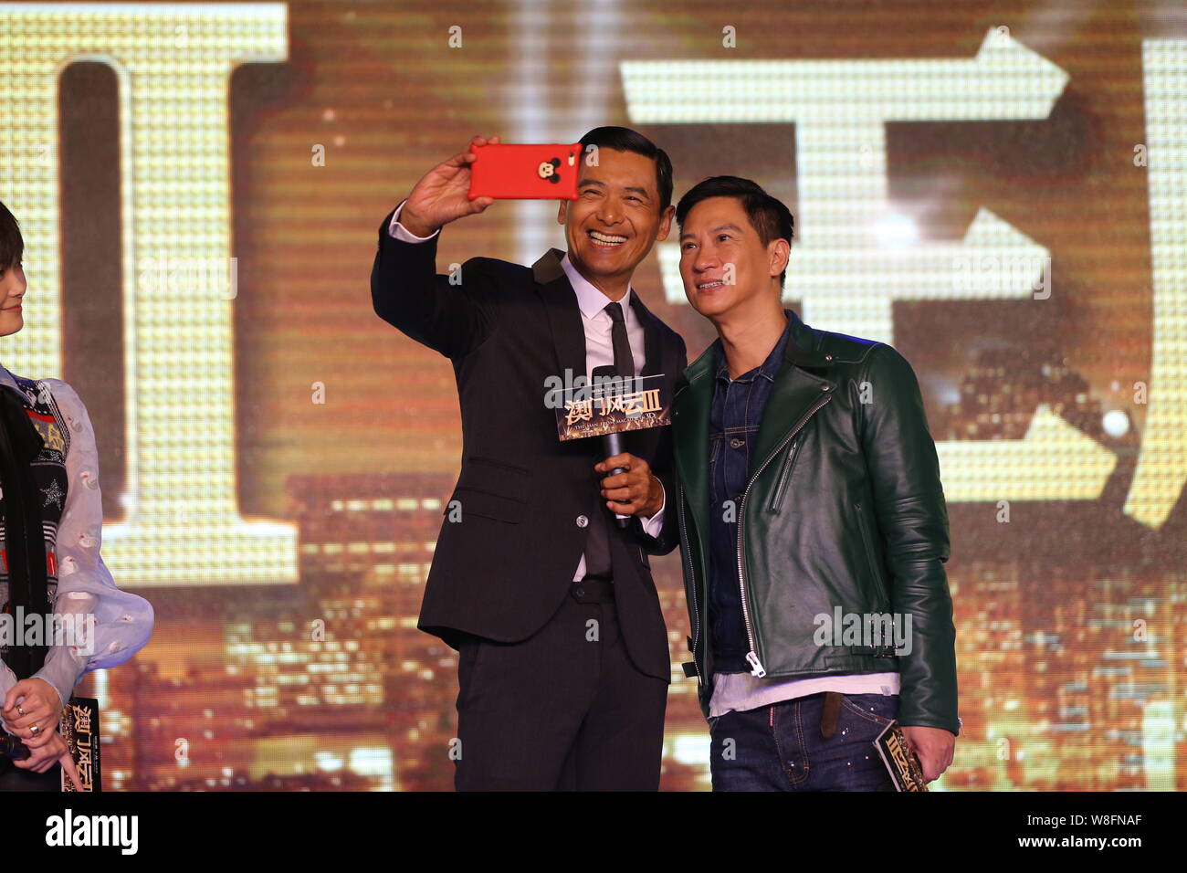 Hong Kong actors Chow Yun-fat, left, and Nick Cheung pose for a selfie ...