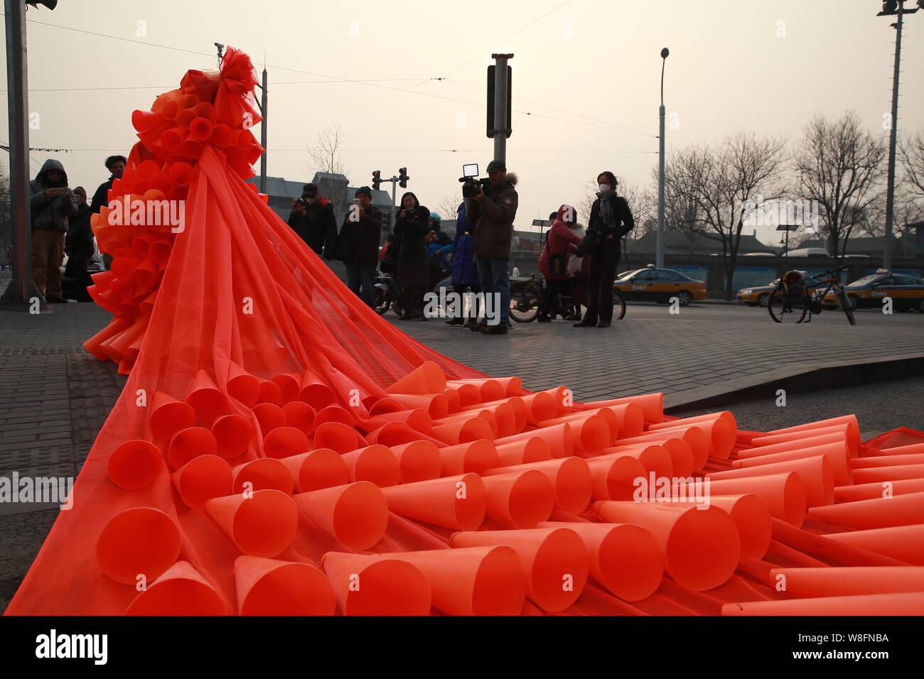 Chinese artist Kong Ning wearing an orange face mask and an orange ...