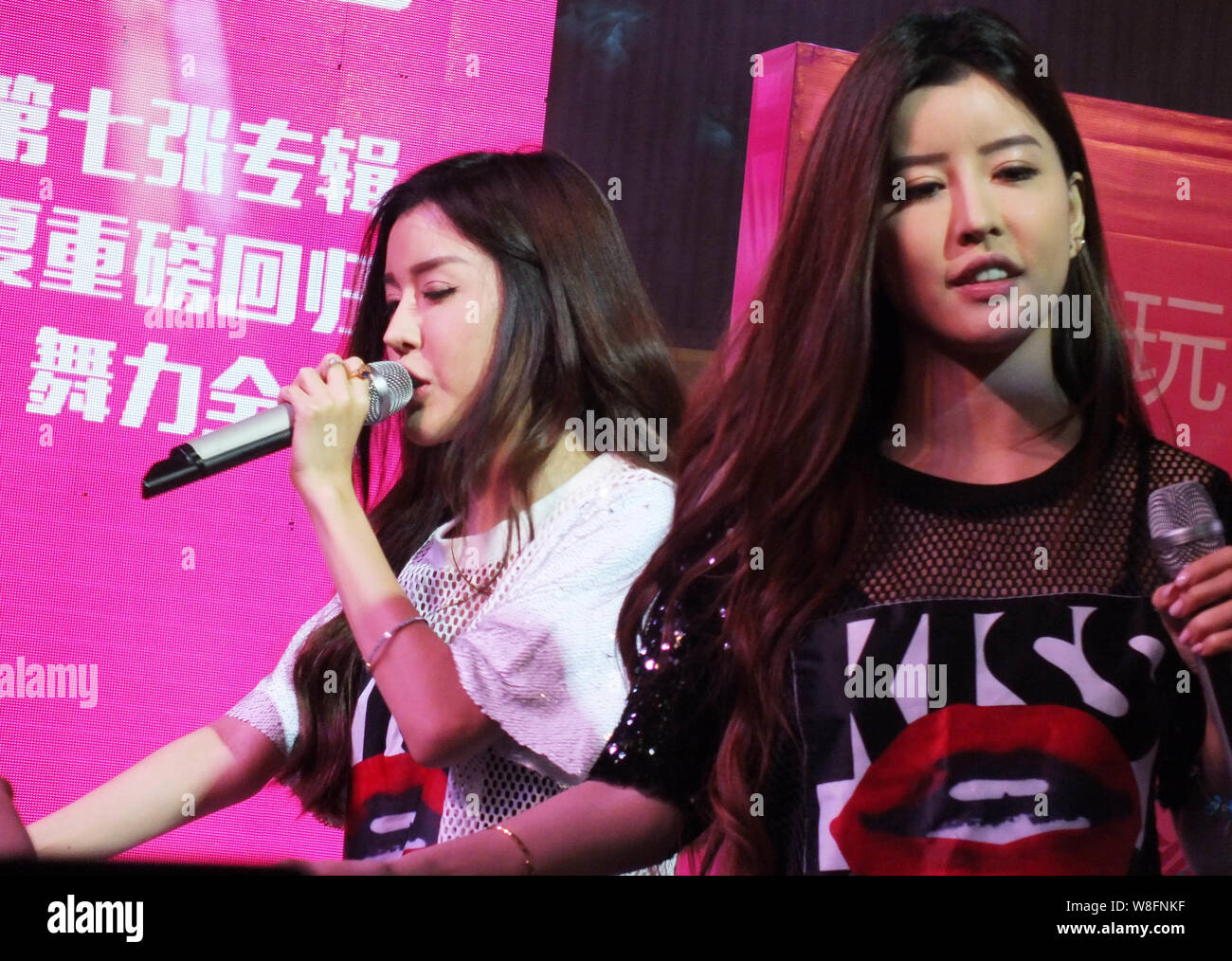 The twin sisters Miko and Yumi of Singaporean pop duo BY2 attend a ...