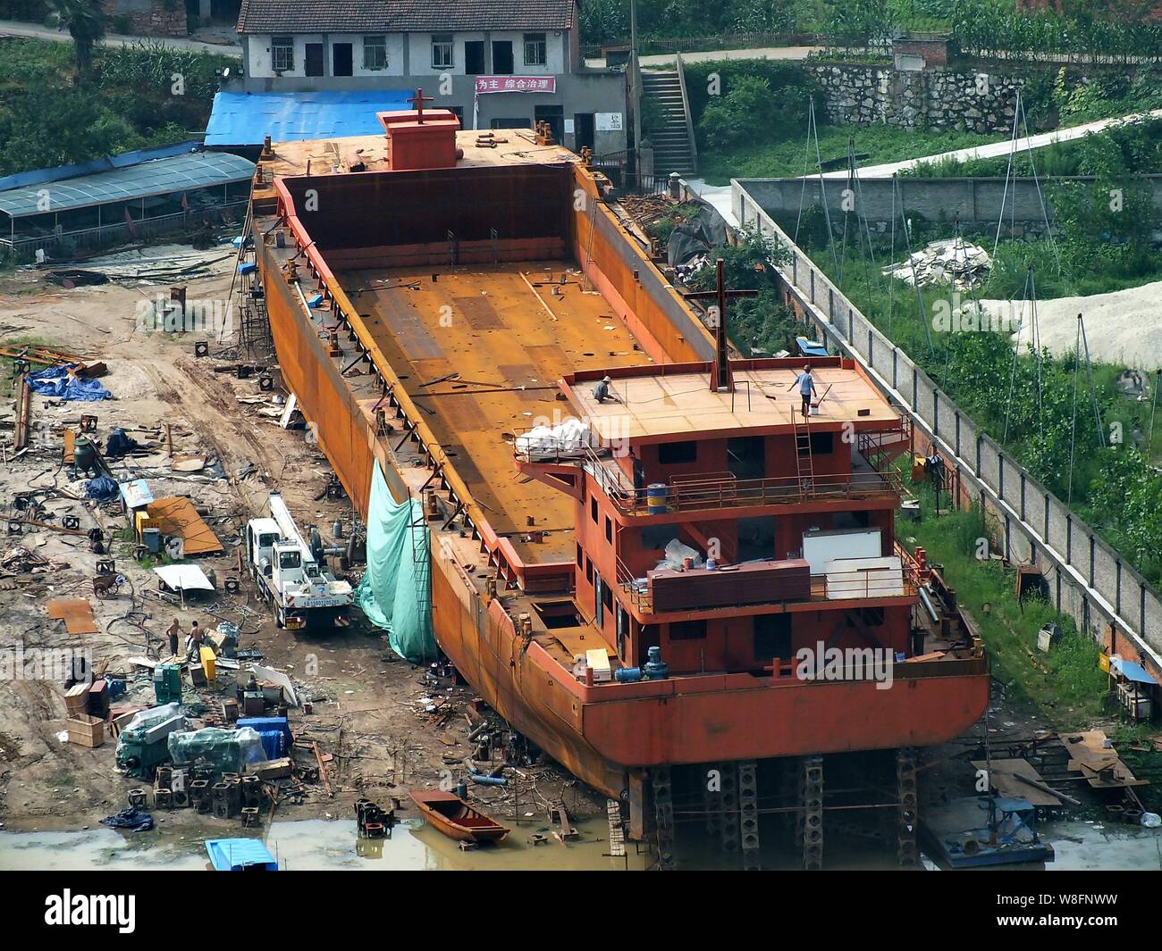 --FILE--A cargo ship is being built at a private shipyard on the bank ...
