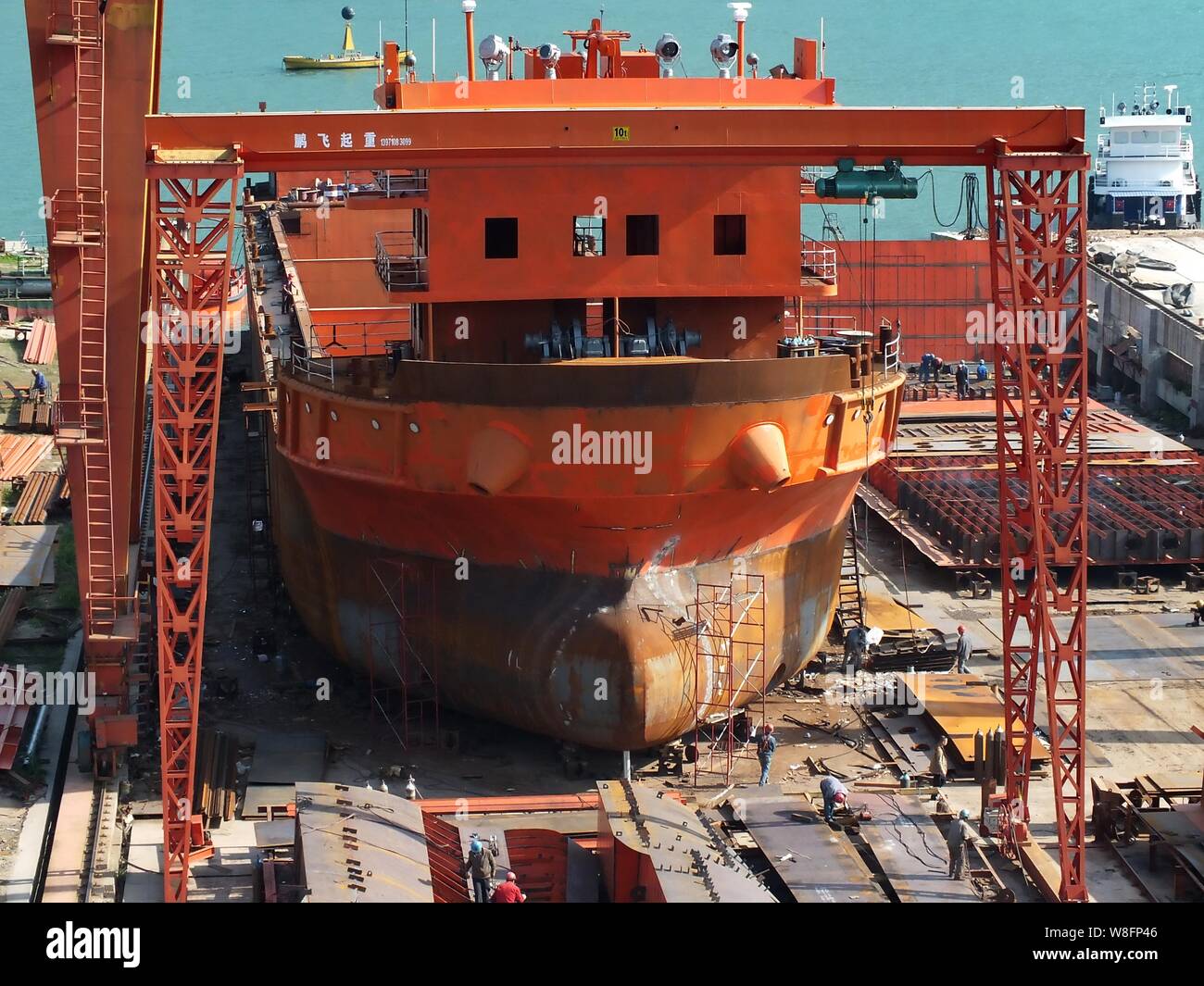 --FILE--A cargo ship is being built at a private shipyard on the bank ...