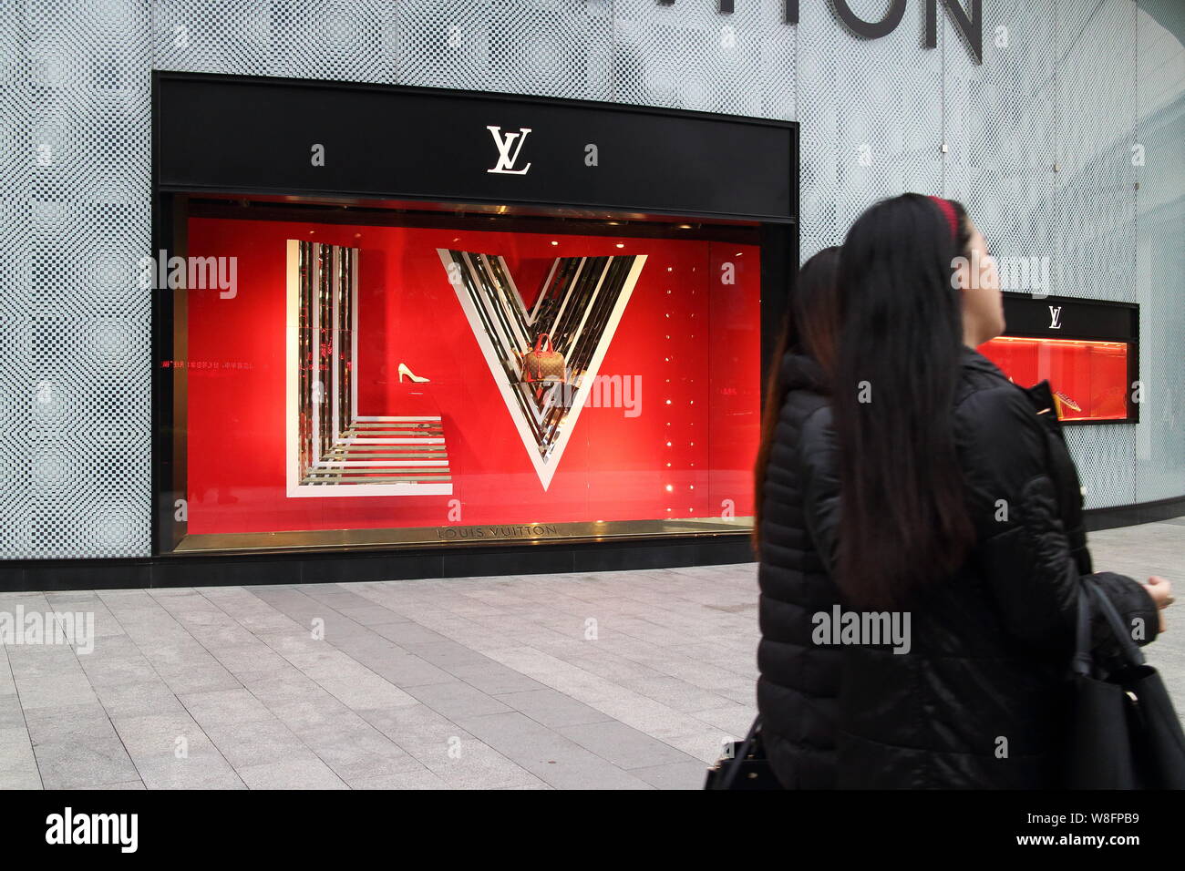--FILE--Pedestrians walk past a Louis Vuitton (LV) boutique of LVMH ...