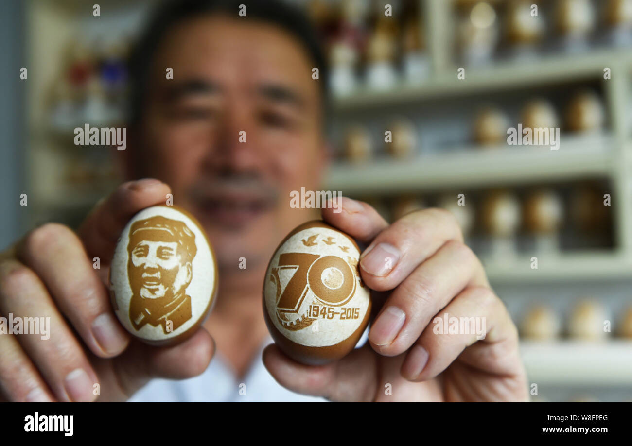 Chinese farmer Li Aimin shows carved eggshells to commemorate the 70th ...
