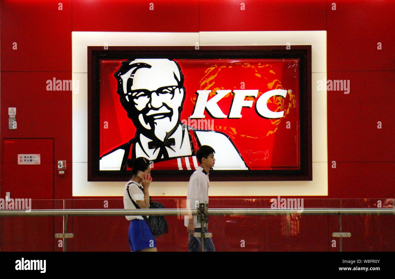 --FILE--Pedestrians walk past a fastfood restaurant of KFC in Chongqing ...