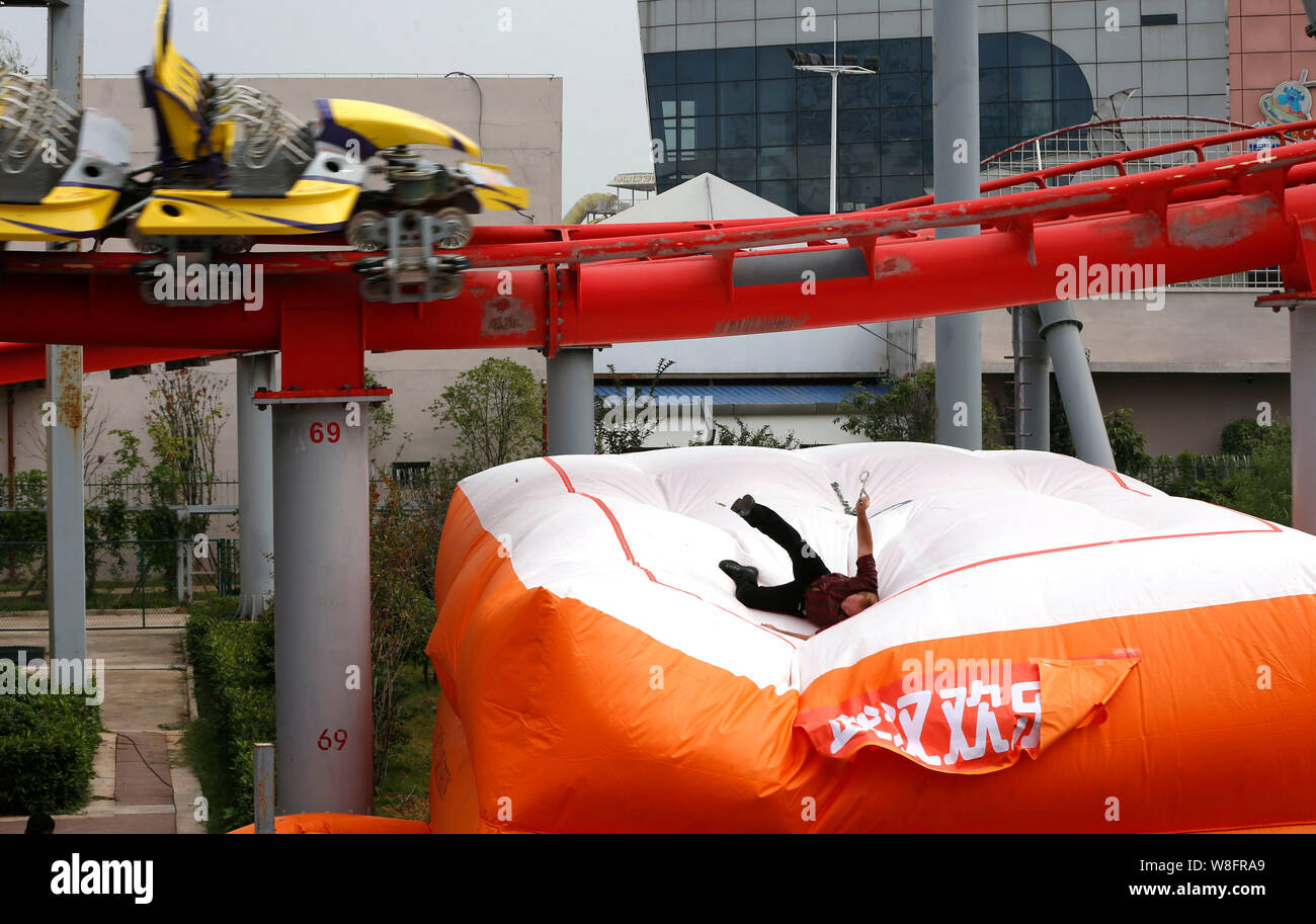 Canadian escapologist Dean Gunnarson jumps off the track of the roller ...