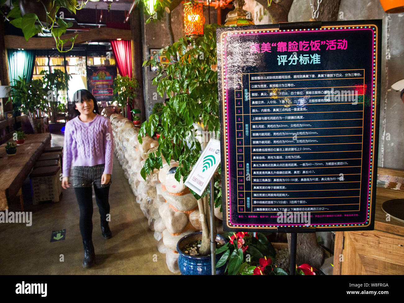 A signboard of scoring standards is displayed on the second floor of a ...