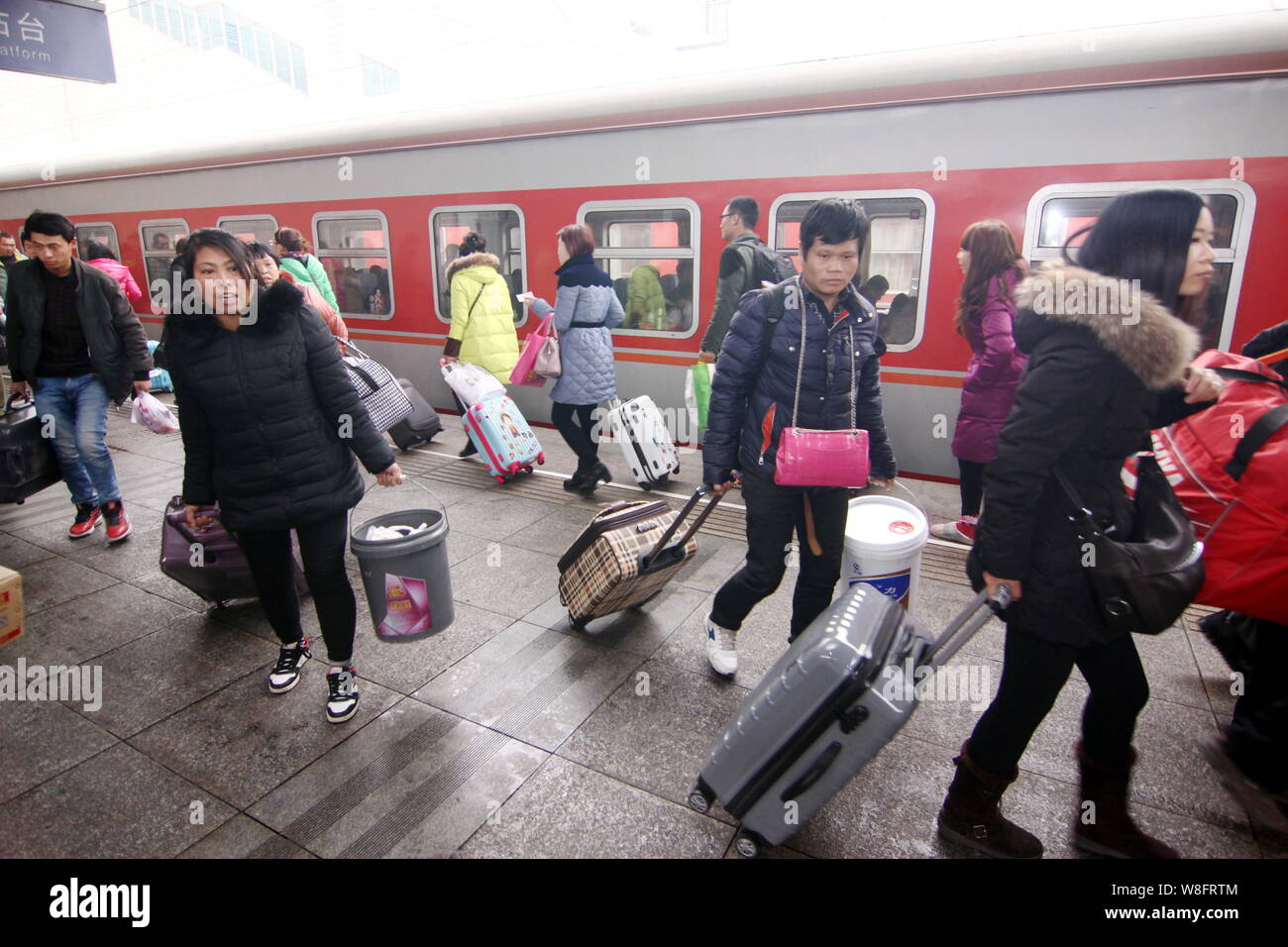 Chinese migrant workers arrive to board trains to go back home for the ...