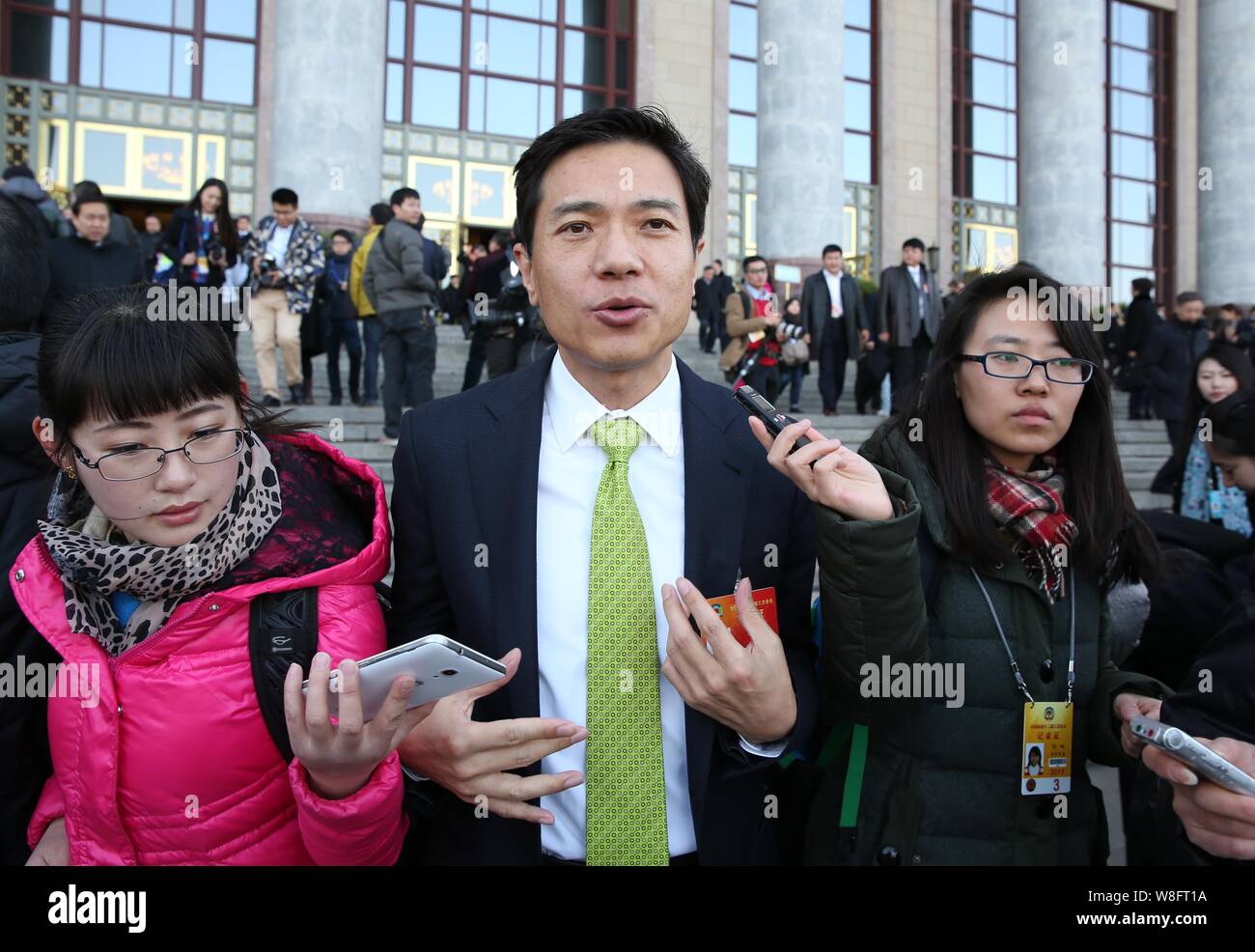 Robin Li Yanhong, center, Chairman and CEO of Baidu, is interviewed as ...