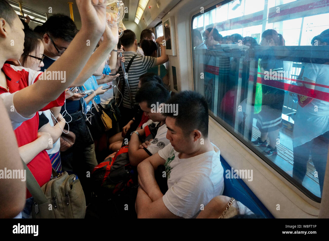 --FILE--Passengers are seen in a crowded subway train in Beijing, China ...