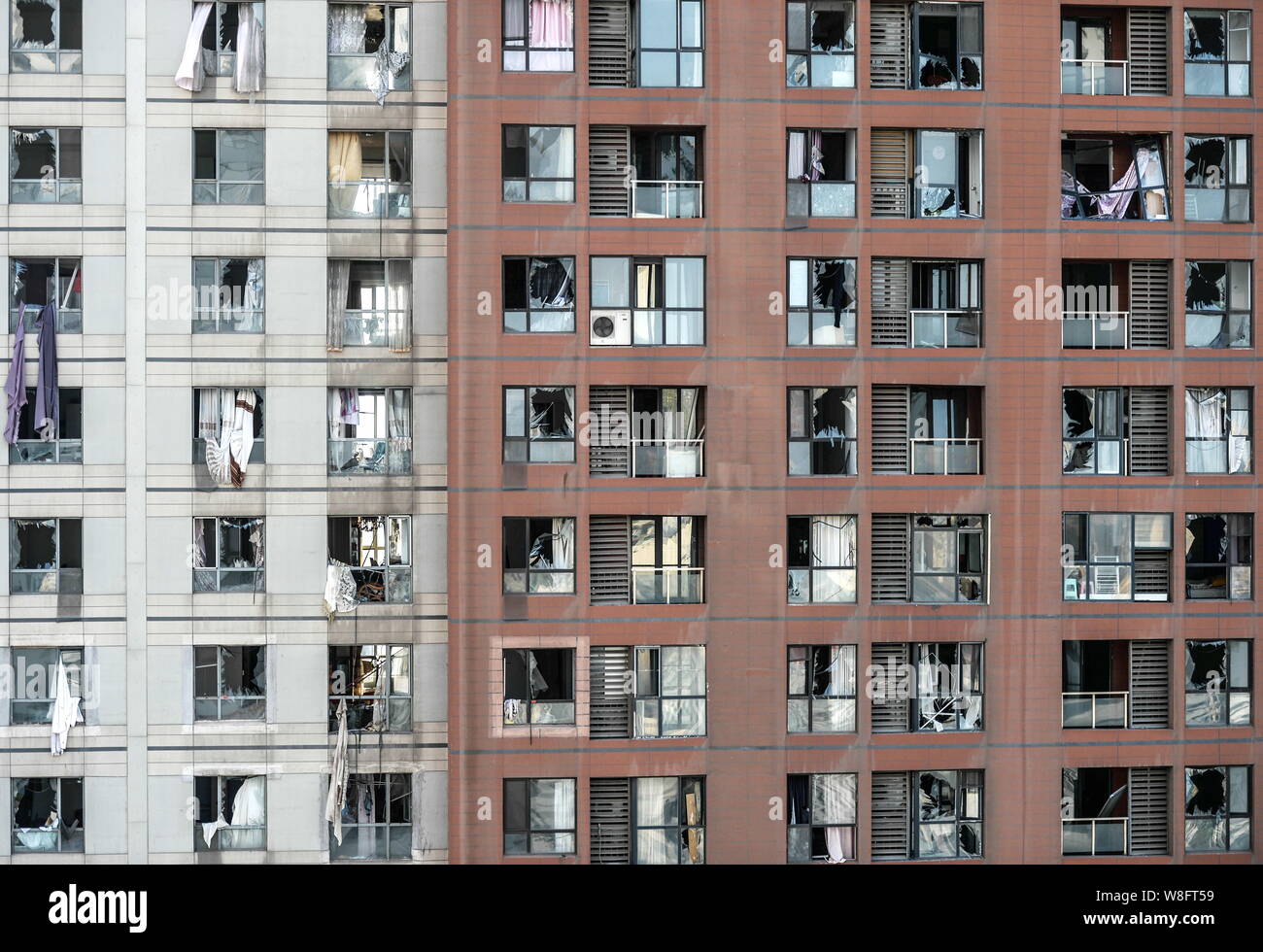 Windows are broken on a high-rise residential apartment building ...
