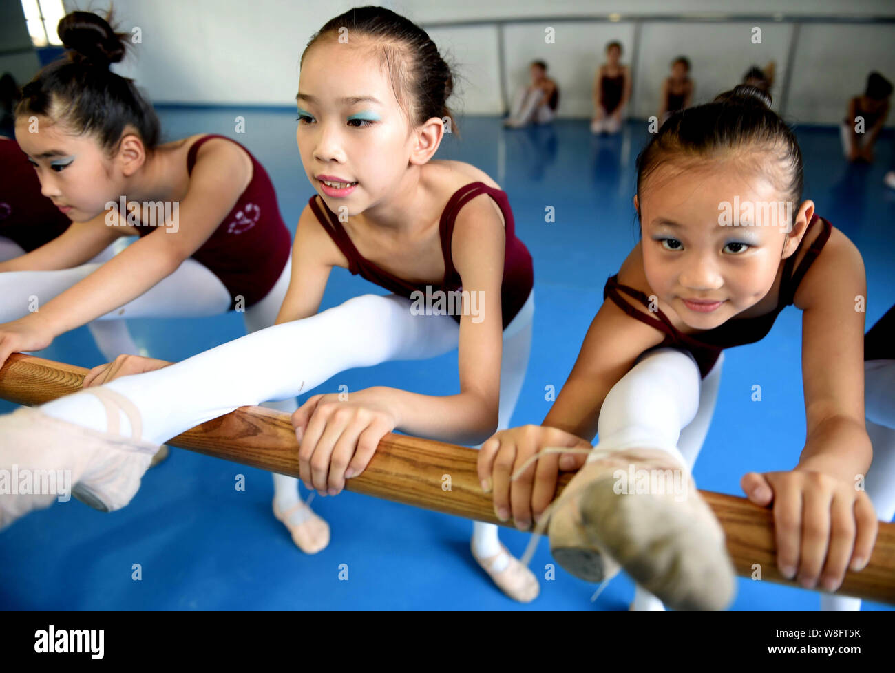 Young Chinese girls practice dancing skills during a training session ...