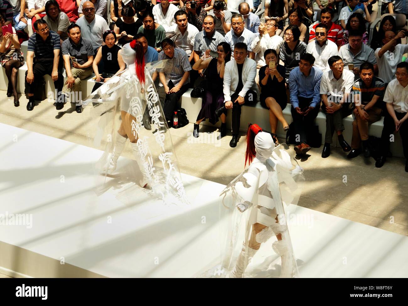 Models display creations of calligraphy during a fashion show at ...