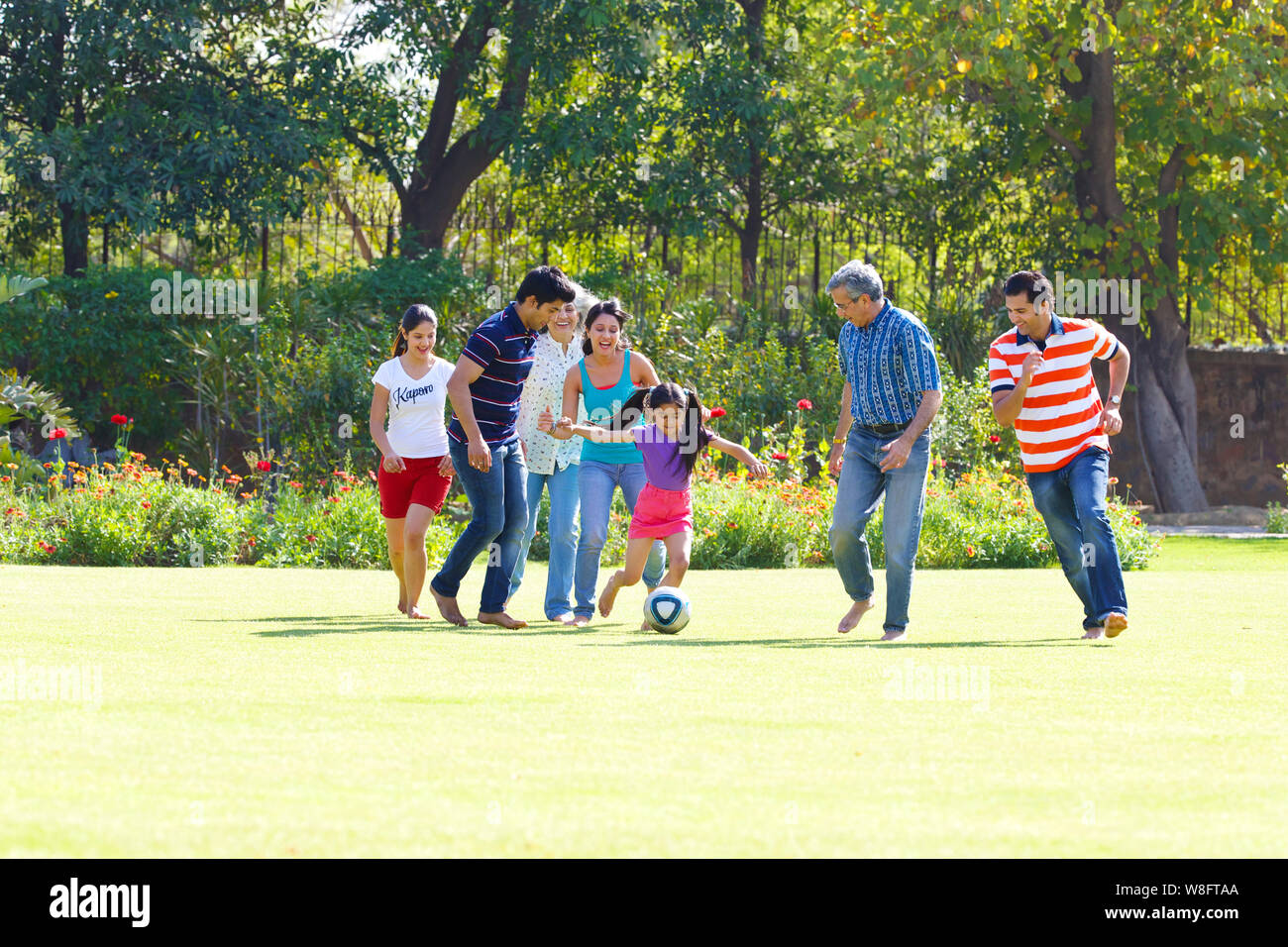 Multi generation family playing soccer hi-res stock photography and ...