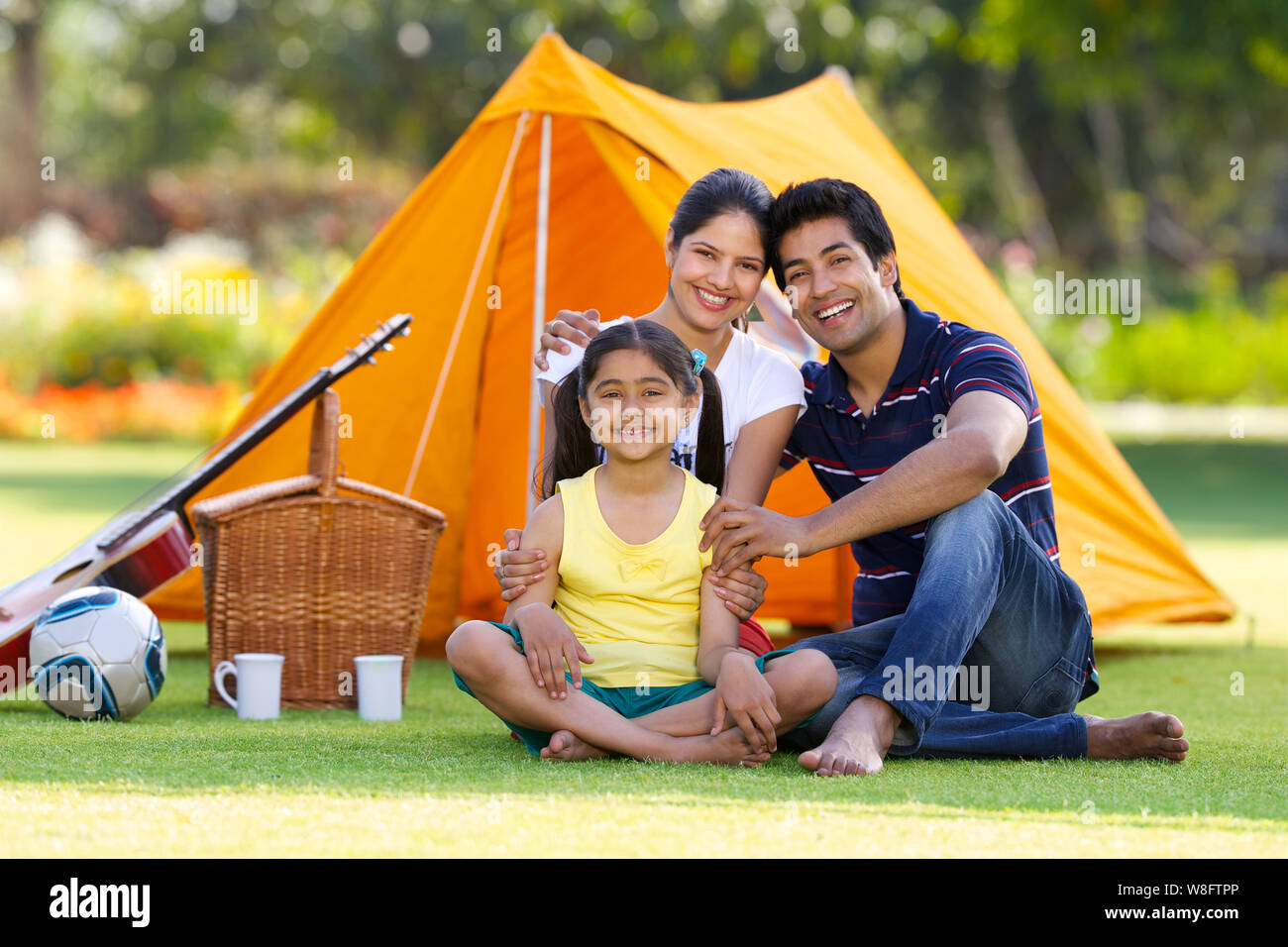 Family having picnic in a park Stock Photo - Alamy