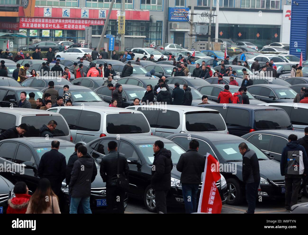 --FILE--Chinese car buyers look at government cars to be auctioned at a ...