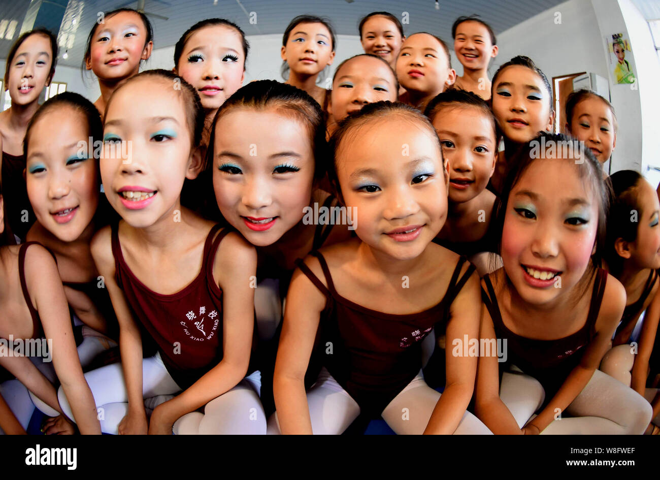Young Chinese girls pose for photos during a training session at Huxiao ...