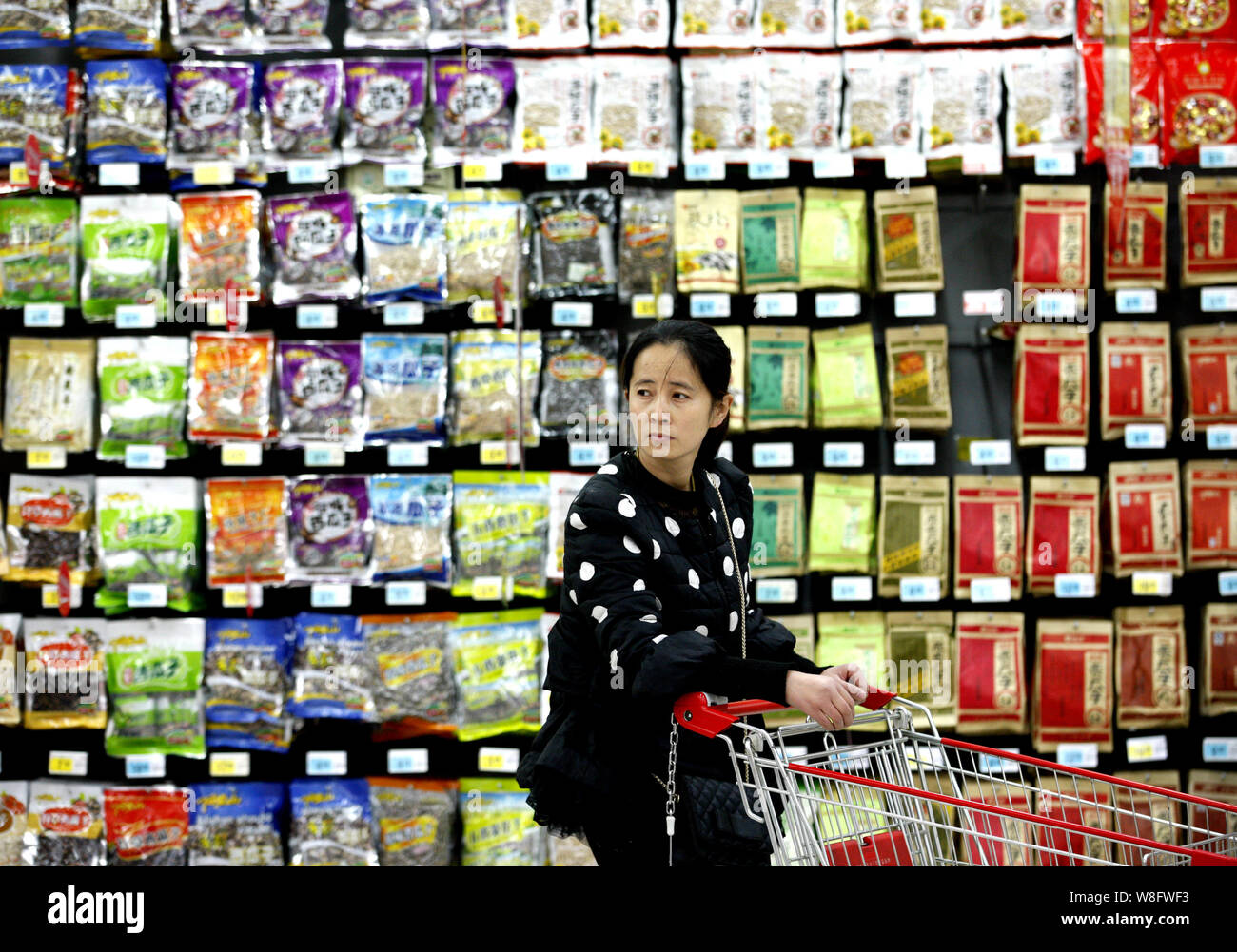 A Chinese customer is shopping at a supermarket in Huaibei city, east ...