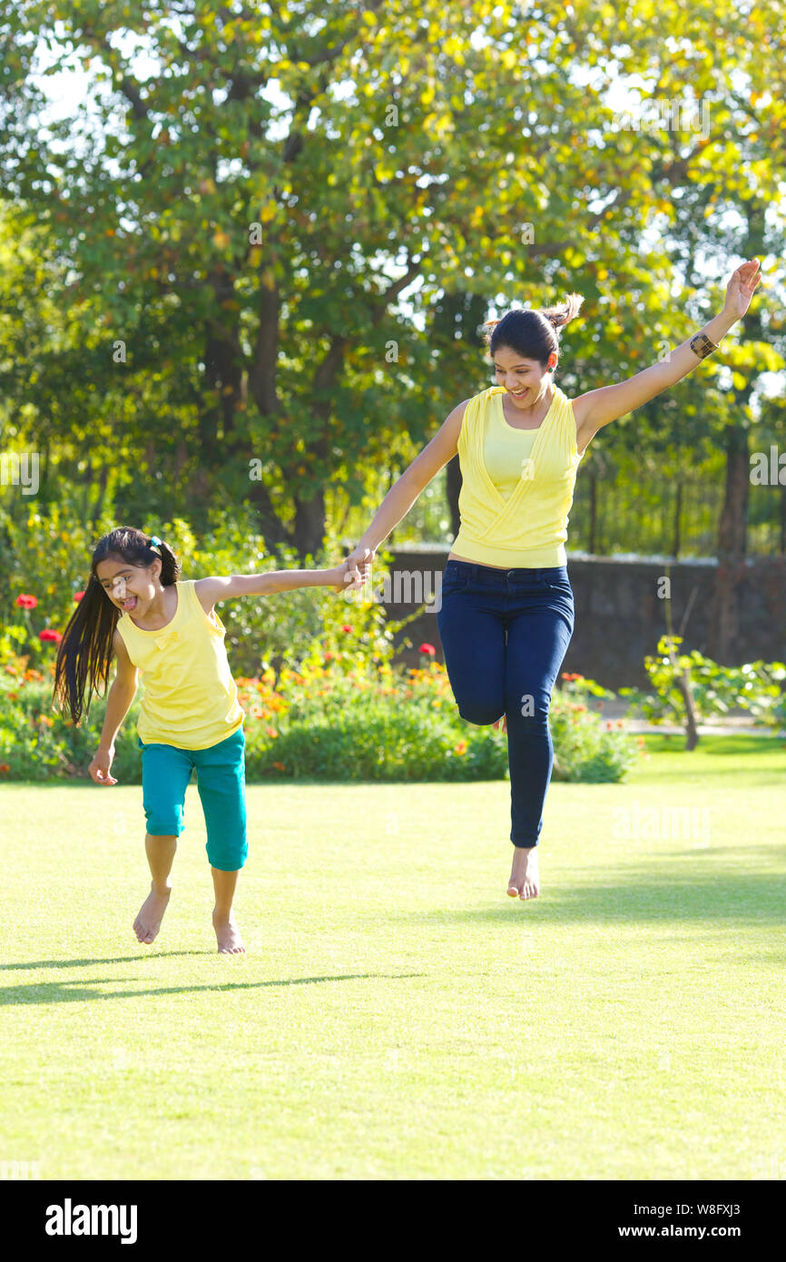 Mother and daughter jumping garden hi-res stock photography and images ...