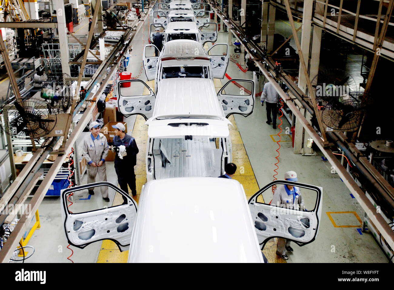 --FILE--Chinese workers assemble vans on the assembly line at an auto ...