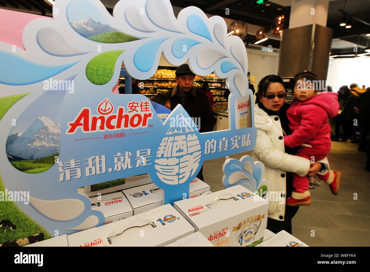 --FILE--Customers walk past cartons of Anchor milk of Fonterra ...