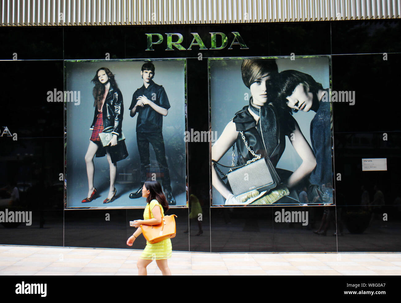 --FILE--A pedestrian walks past a boutique of Prada in Chongqing, China ...