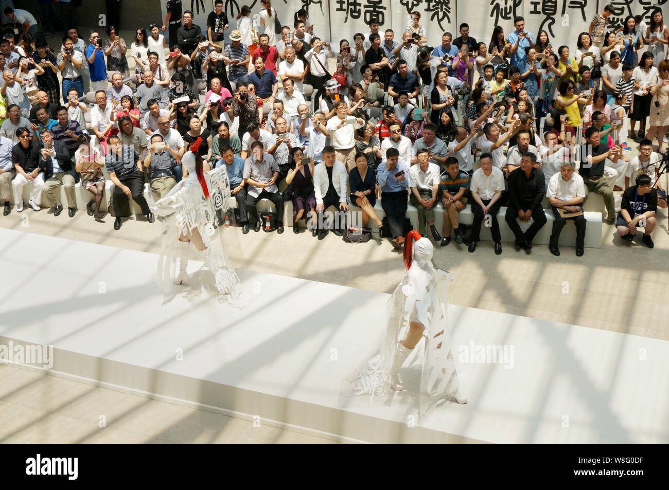 Models display creations of calligraphy during a fashion show at ...