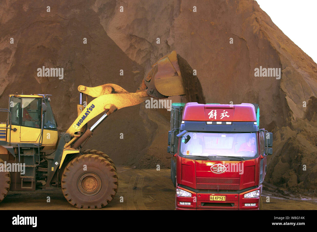 --FILE--A wheel loader loads a truck with iron ore at the Port of ...