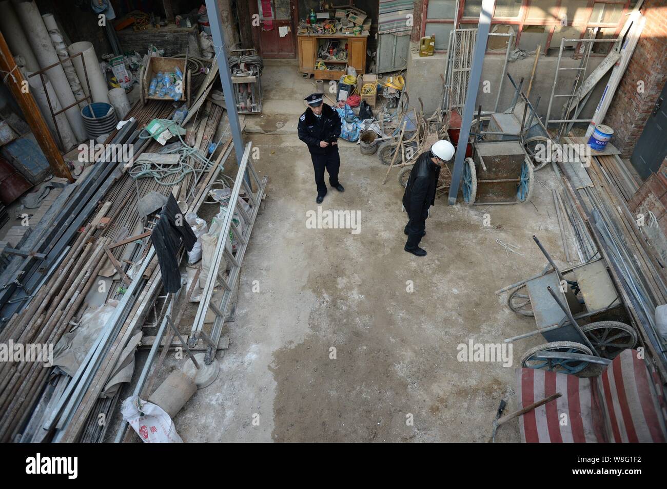 Chinese law enforcement officers check the backfilling of a three-level ...