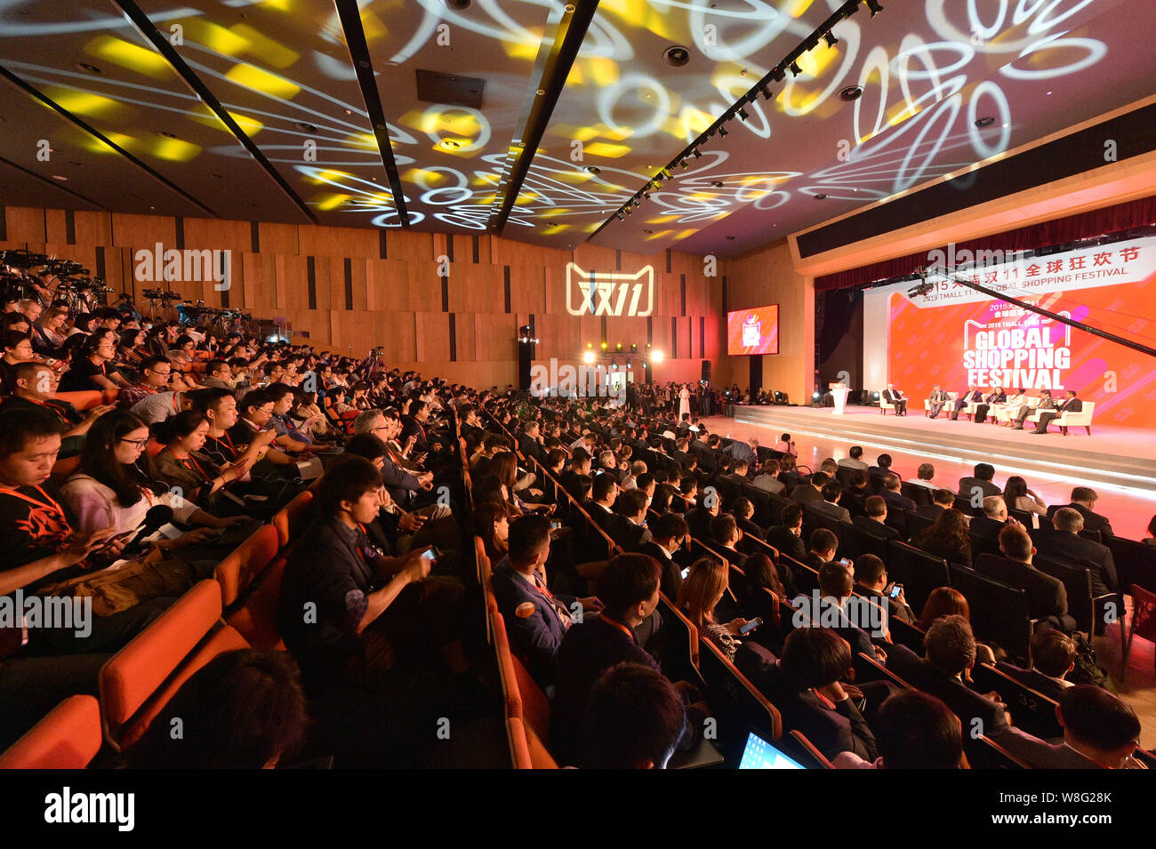 People attend the launch event of the 2015 Tmall 11.11 Global Shopping Festival at Alibaba's ...