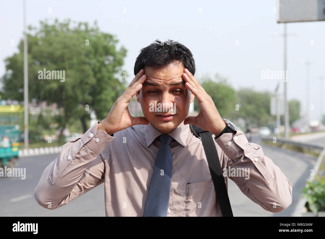 Sales executive suffering from headache Stock Photo - Alamy