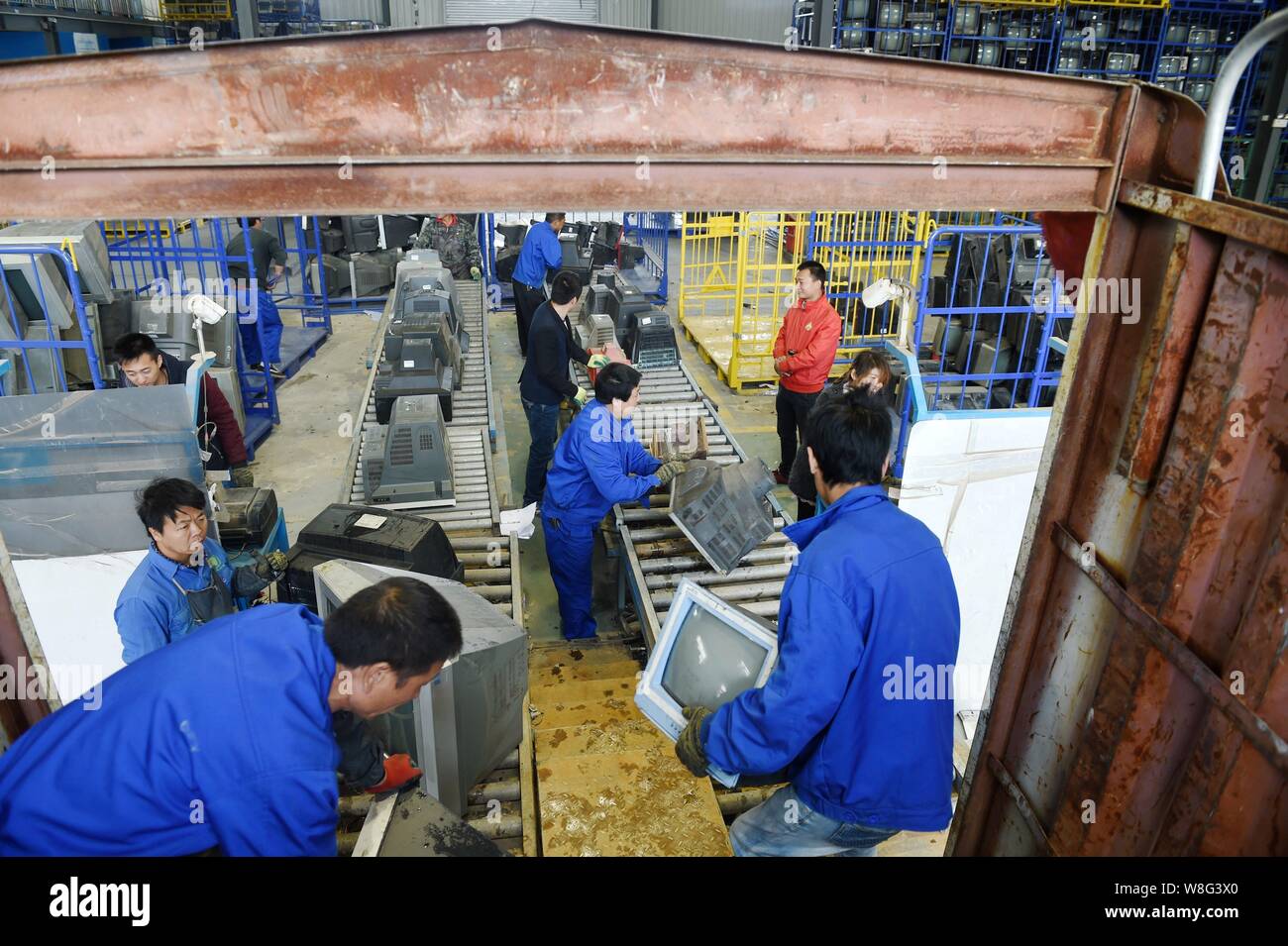 Chinese workers unload discarded CRT TV sets to be disassembled and ...