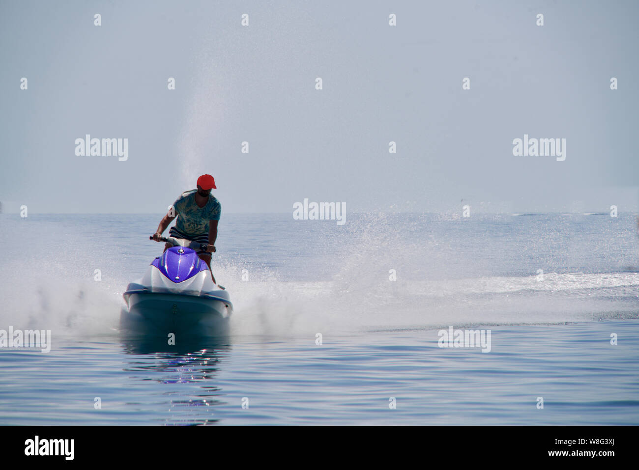 man driving with a jetski on the ocean Stock Photo - Alamy