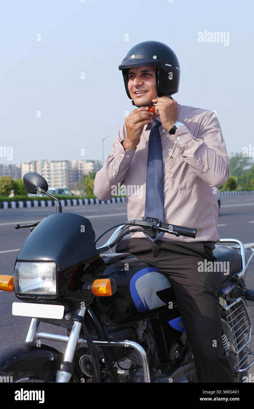 Sales executive sitting on a motorcycle and wearing a helmet Stock ...