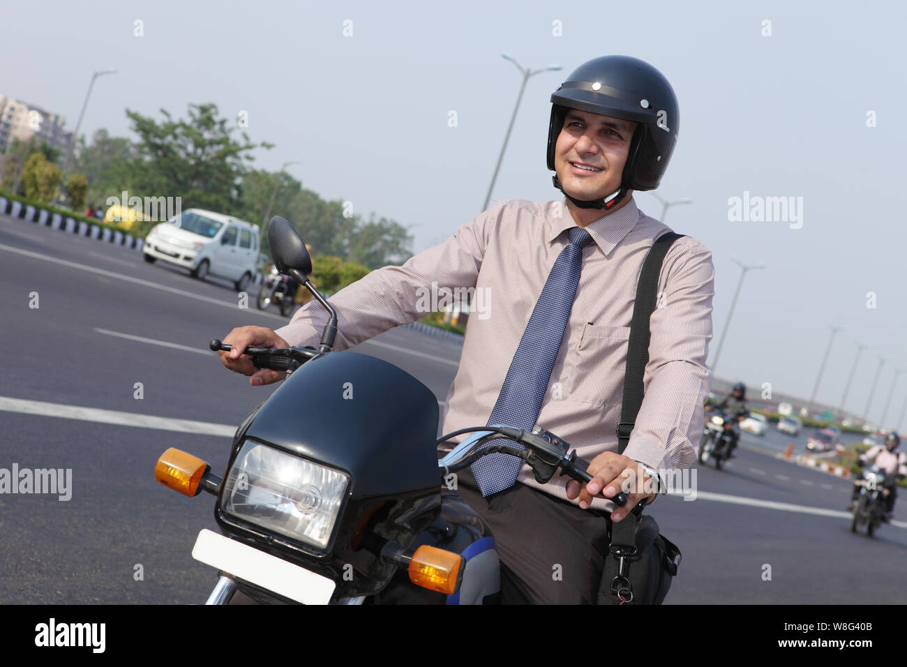 Sales executive riding a motorcycle Stock Photo - Alamy