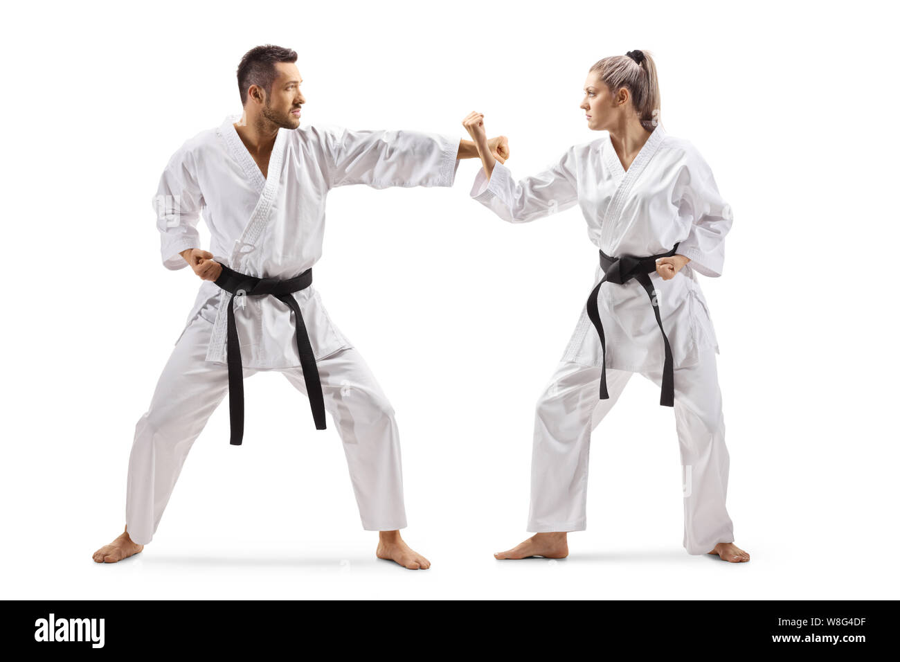 Full length profile shot of a man and woman practicing karate isolated ...