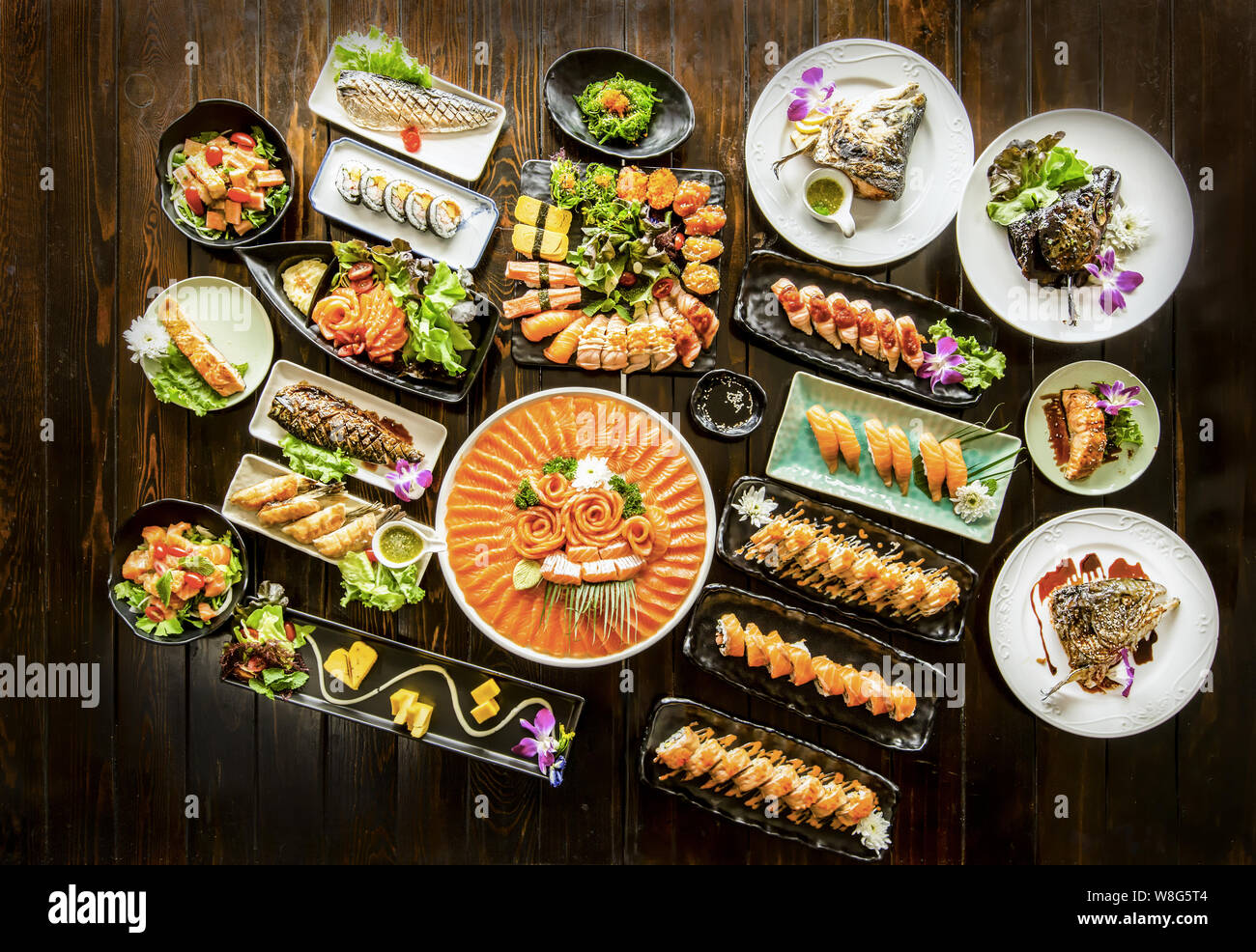 Set of salmon sushi maki and rolls, grill saba fish at black rustic ...