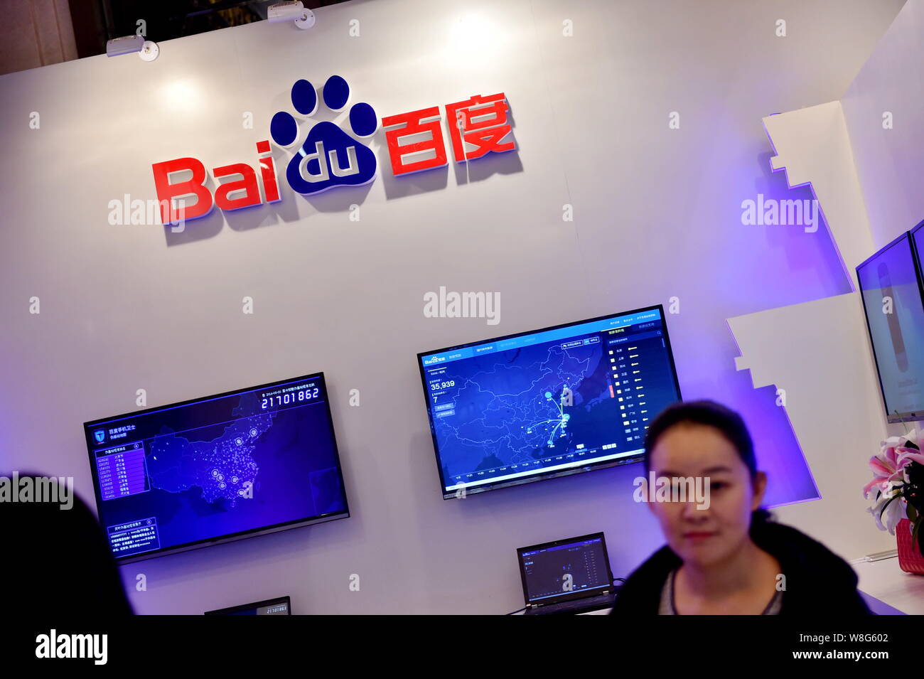 --FILE--A Chinese employee is seen at the stand of Baidu during the ...