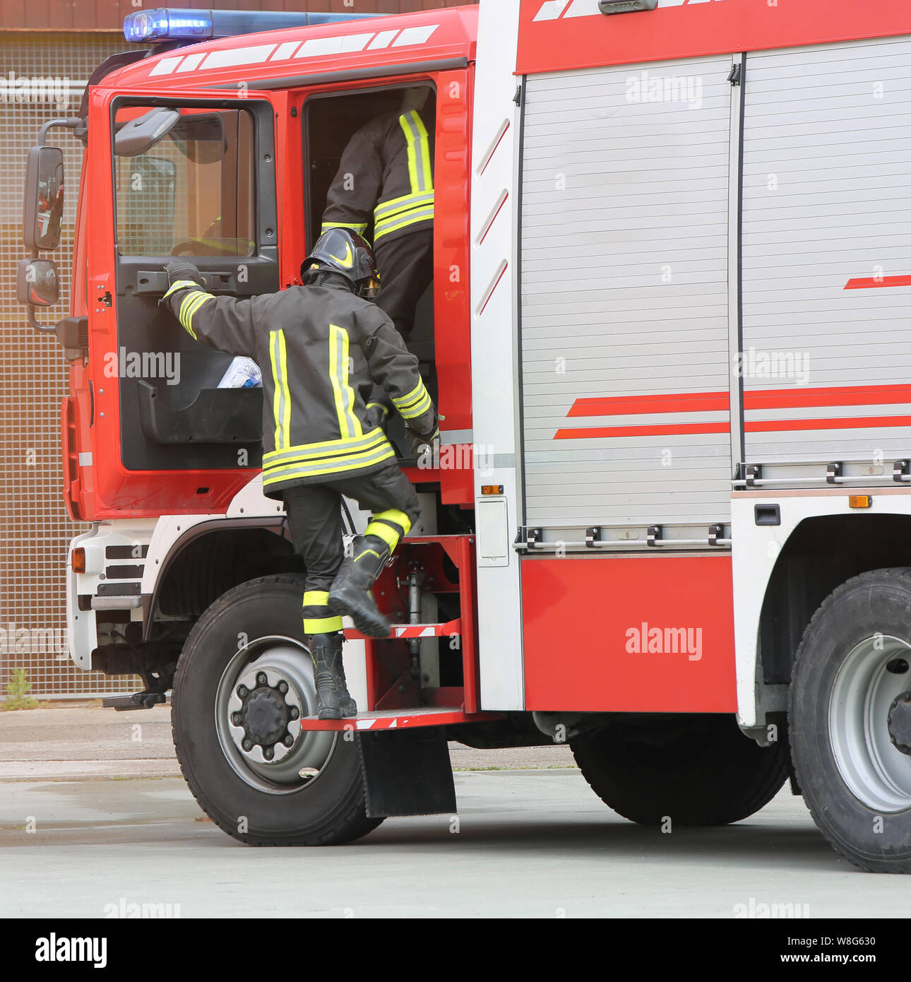 fireman and the fire engine during an emergency Stock Photo - Alamy