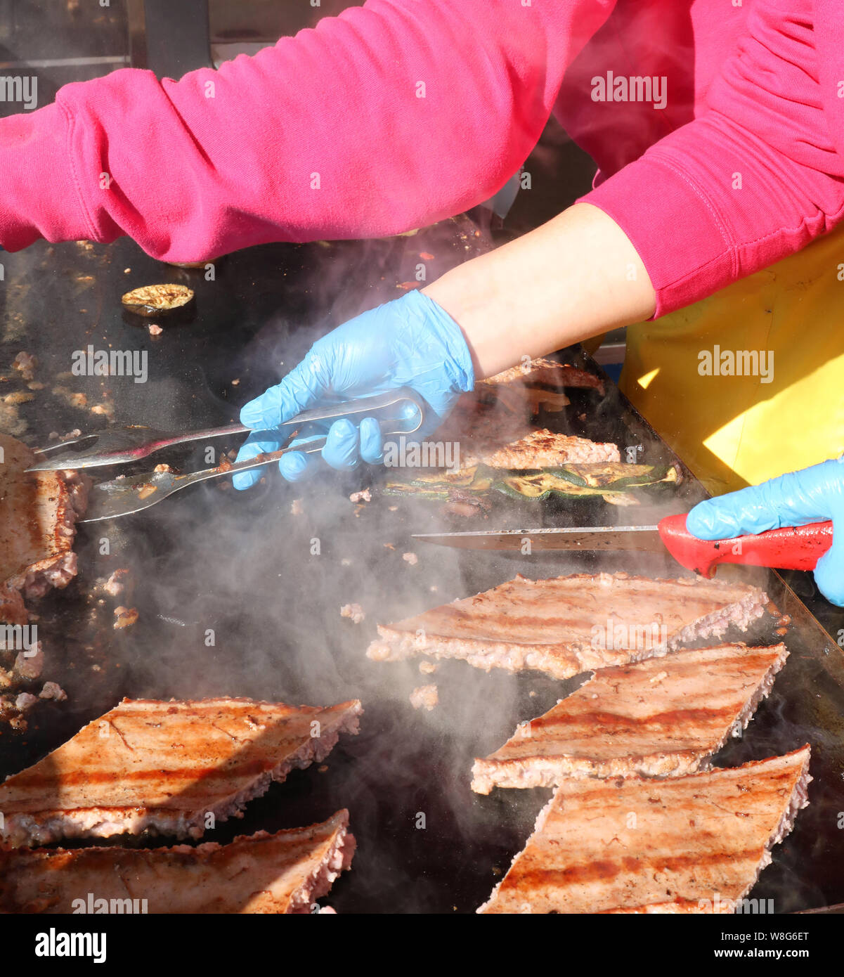 hand of chef with blue latex gloves and many sausages Stock Photo - Alamy
