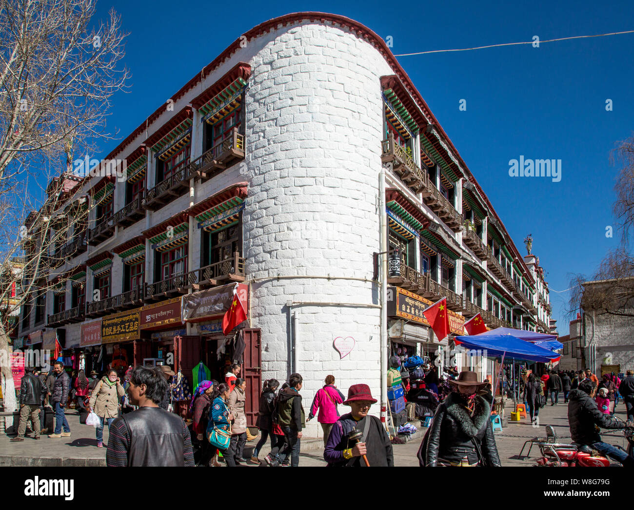 --FILE--Tourists and local Tibetan people walk on the square in front ...