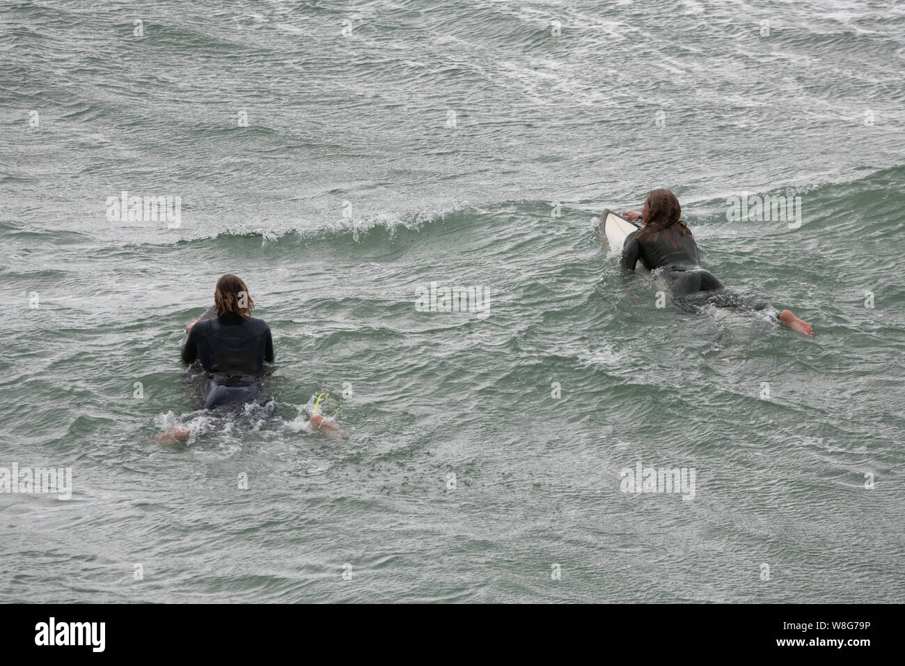 Bournemouth, UK. 9th Aug, 2019. Surfers and RNLI staff make the most of ...